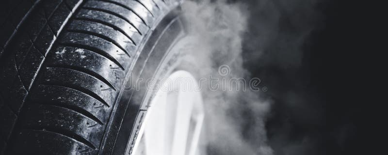 A Car Tire with Smoke Surrounding it on a Dark Backdrop , Horizontal ...