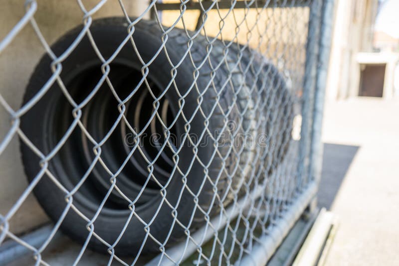 Car Tire Stack Seen through Fence Stock Photo - Image of profile ...