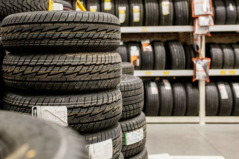Car Tires and Wheels at Warehouse in Tire Store Stock Photo - Image of ...
