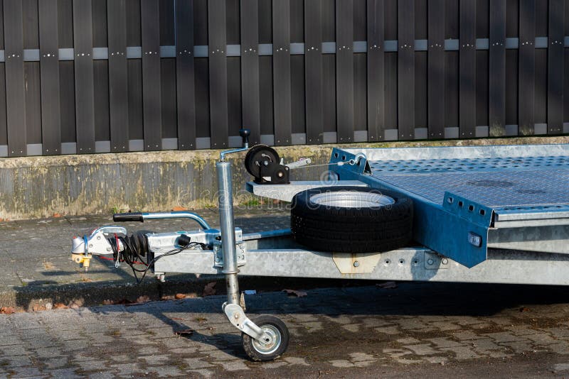 Car Trailer on Display with Single Tire Resting beside it Stock Image ...