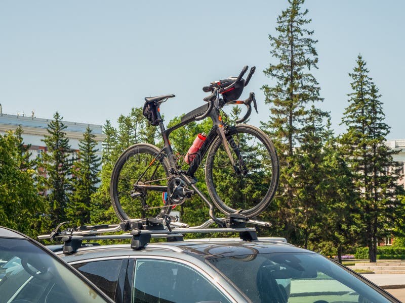 Car is Transporting Black Bicycle on the Roof Stock Photo - Image of ...