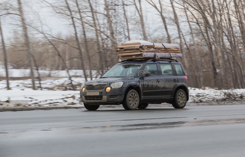 Car Transports Cardboard Boxes on the Trunk on a Winter Road Stock ...