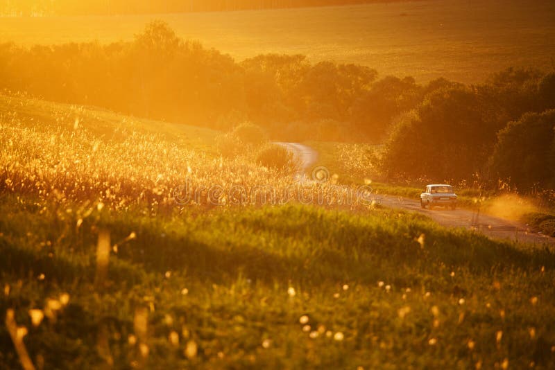 Car Traveling on a Country Road among Fields Stock Image - Image of ...