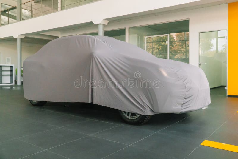 The Car Under the Protective Cover is in the Showroom Stock Photo ...