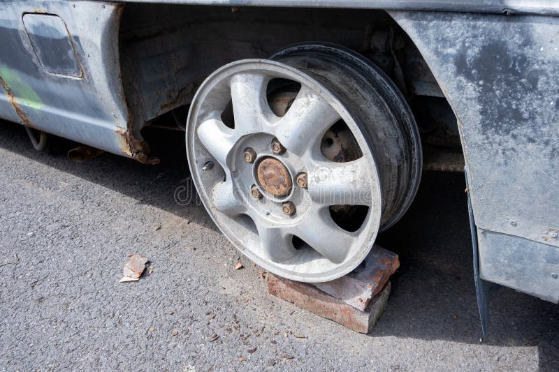 Car with a Wheel on Bricks without a Tire Stock Image - Image of ...