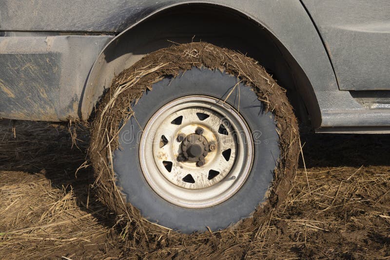 A Car Wheel Covered in Field Mud on a Spring Day Stock Image - Image of ...