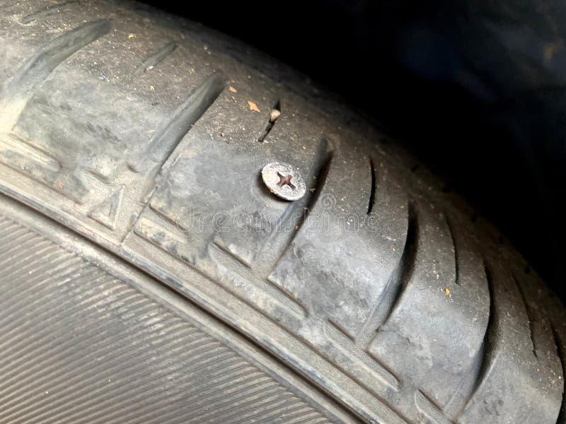 Car Wheel Punctured by Sharp Nail into Deep Tire during Driving on the ...
