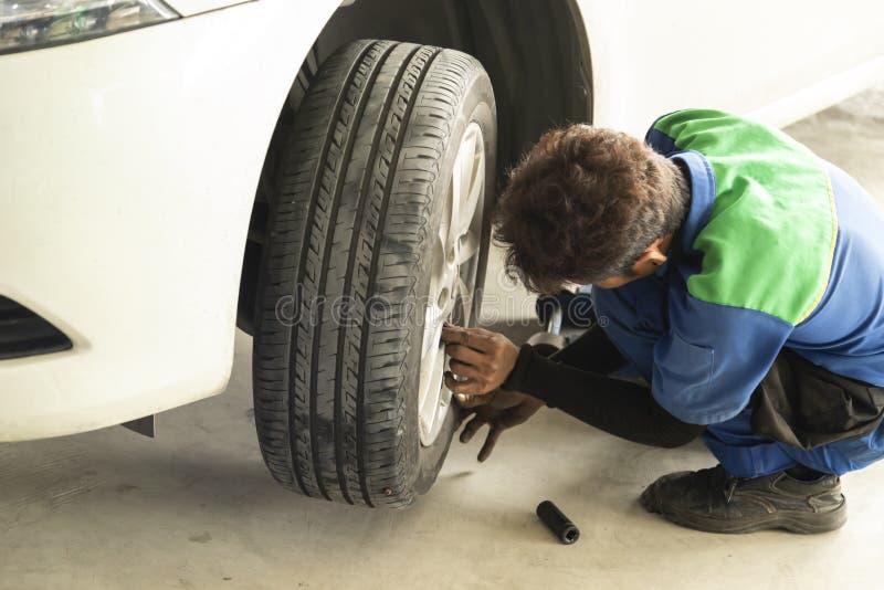 Mechanic Changing Car Wheel with Impact Wrench at Service Shop Stock ...
