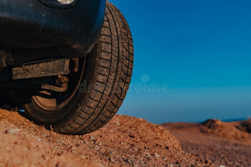 Car wheel on sand close-up stock photo. Image of travel - 305575296