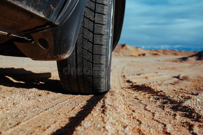 Car wheel on sand stock photo. Image of travel, rubber - 322604688