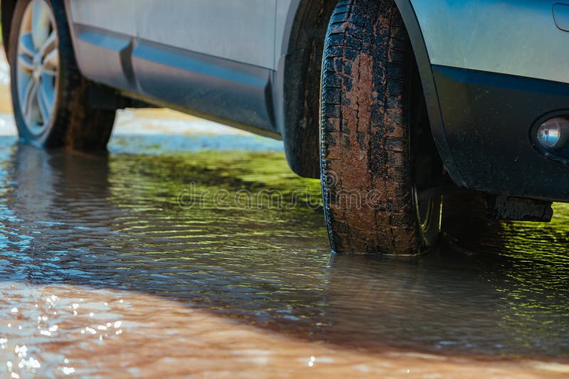 Car Wheel Standing Offroad in a Muddy Puddle Stock Photo - Image of ...