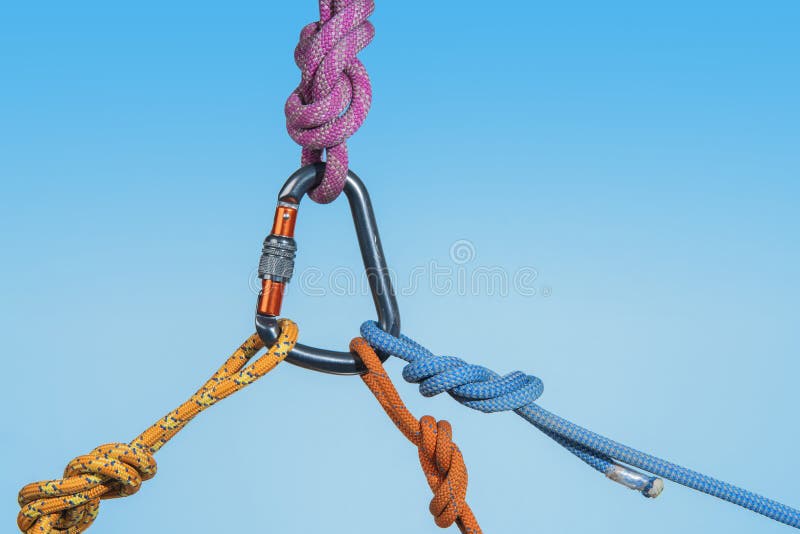 Carabiner System Securing 3 Lines of Rope Against a Blue Background ...