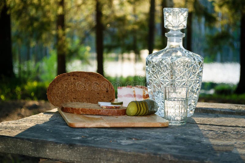 A Carafe of Alcohol and Snack on the Shore of the Lake Stock Photo ...