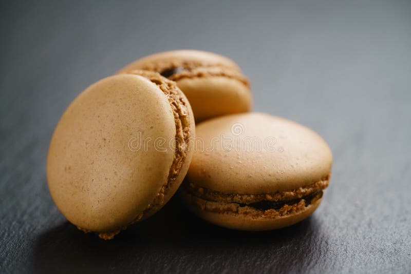 Caramel Brown Macarons on Slate Background Stock Image - Image of ...