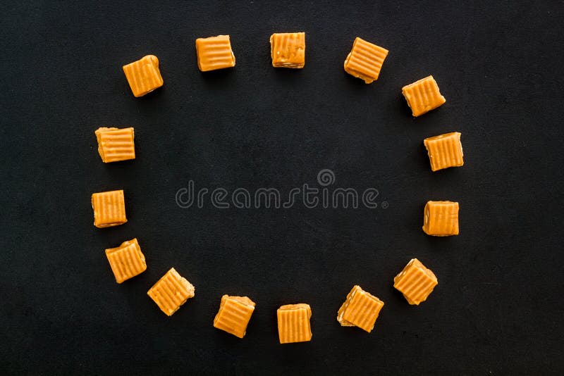 Caramel Pieces - Round Lined with Sweets - on Black Background Top View ...