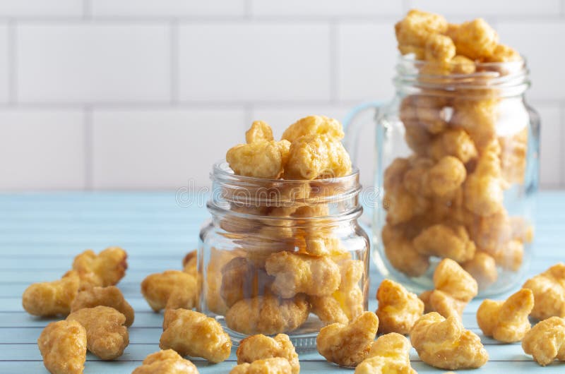 Caramel Puff Corn Popcorn in Glass Jars on a Blue Wood Counter Stock ...