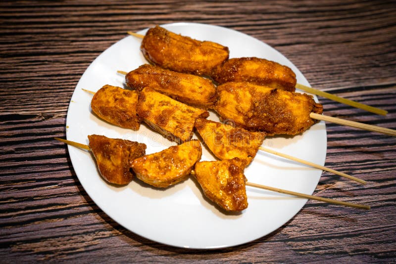 Caramelized Banana and Kamote Que in a Stick on White Plate Stock Image ...