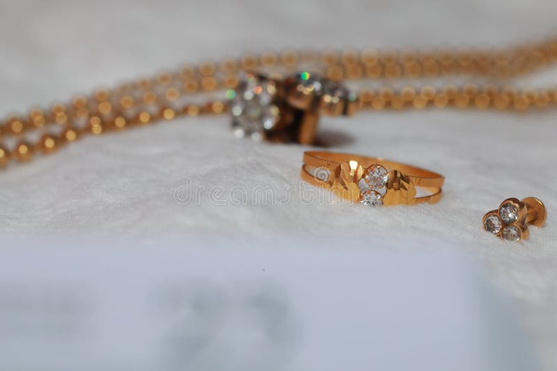 24 Carat Gold Chain and Ring Isolated in White Backdrop Stock Image ...