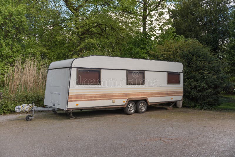 Caravan parked in the wood stock photo. Image of rural - 135530072