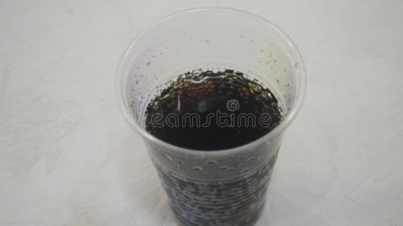 Carbon Dioxide Bubbles in a Plastic Cup with Cola. Stock Footage ...
