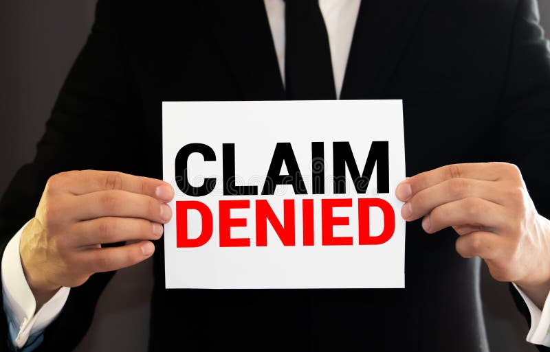 CLAIM DENIED Text on Easel with Wooden Figure, Meeting Concept Stock ...