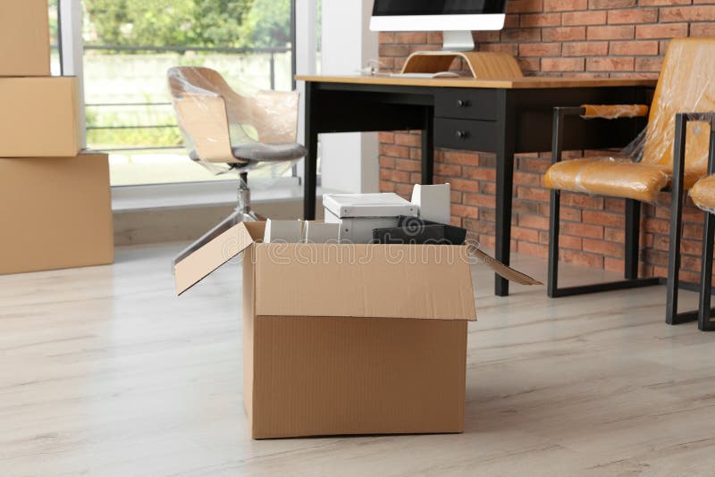 Cardboard Box with Belongings and Packed Chair in Office Stock Photo ...