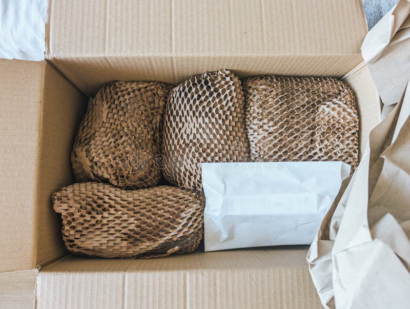 Cardboard Box Containing Wrapped Items with Protective Paper and ...
