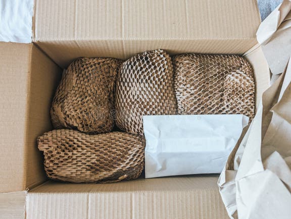 Cardboard Box Containing Wrapped Items with Protective Paper and ...