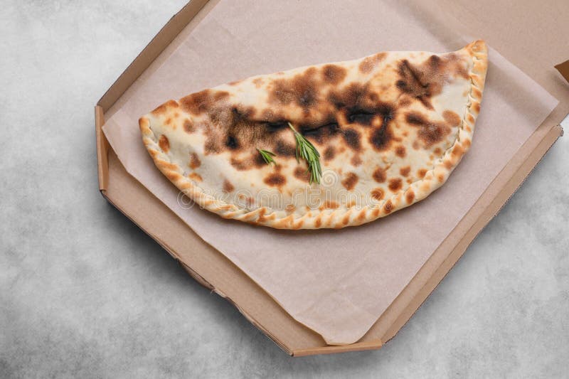 Cardboard Box with Delicious Calzone on Grey Table, Top View Stock ...