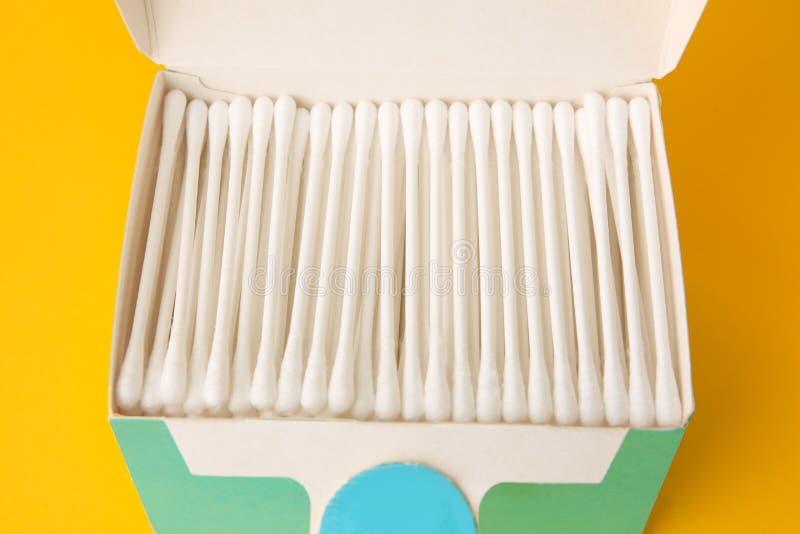 Cardboard Box with New Cotton Buds on Yellow Background, Closeup Stock ...