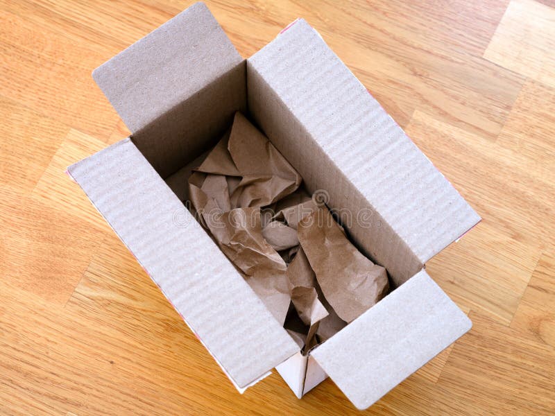 A Cardboard Box with Paper Inside on Parquet Floor Stock Image - Image ...