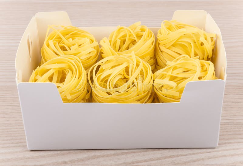 Cardboard Box with Pasta in Form Nest on Table Stock Image - Image of ...
