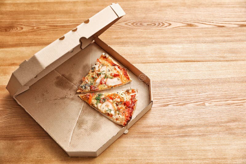 Cardboard Box with Pizza Pieces on Wooden Table. Stock Image - Image of ...