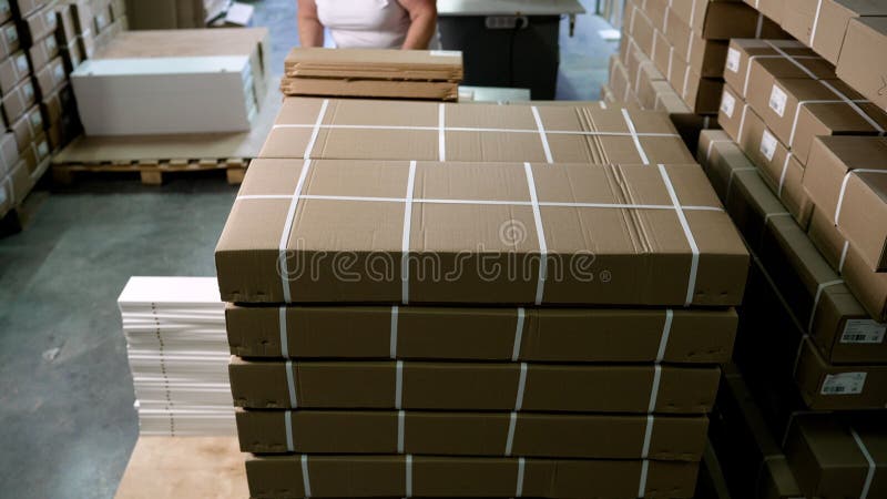 Cardboard Box Sliding on Stack of Boxes in Warehouse Stock Photo ...