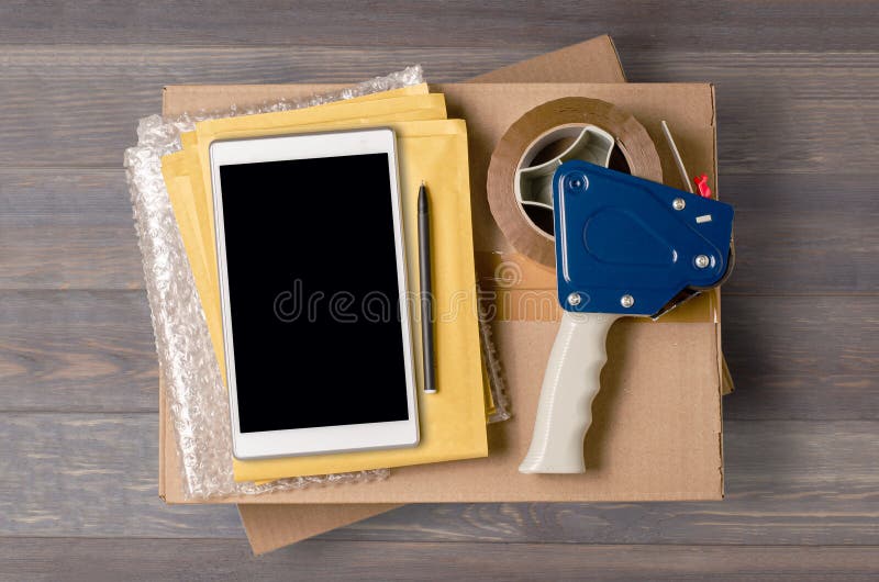Cardboard Box, Smartphone, Bubble Wrap and Packaging Tools. the Concept ...
