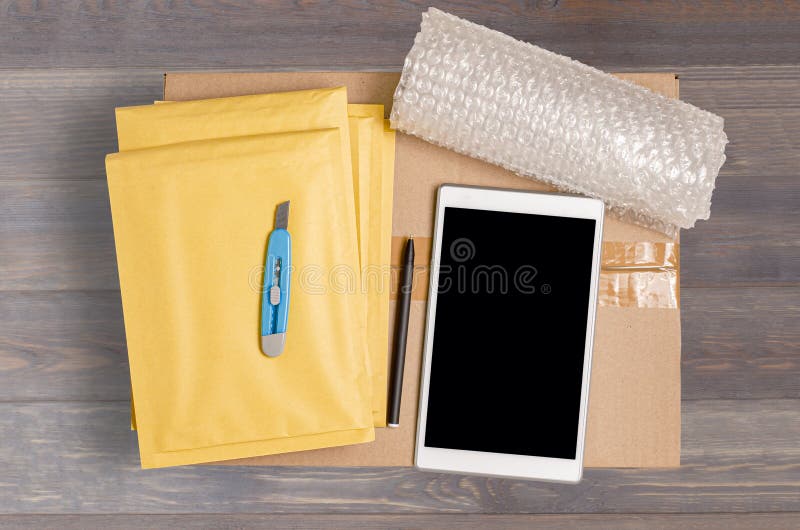 Cardboard Box, Smartphone, Bubble Wrap and Packaging Tools. the Concept ...