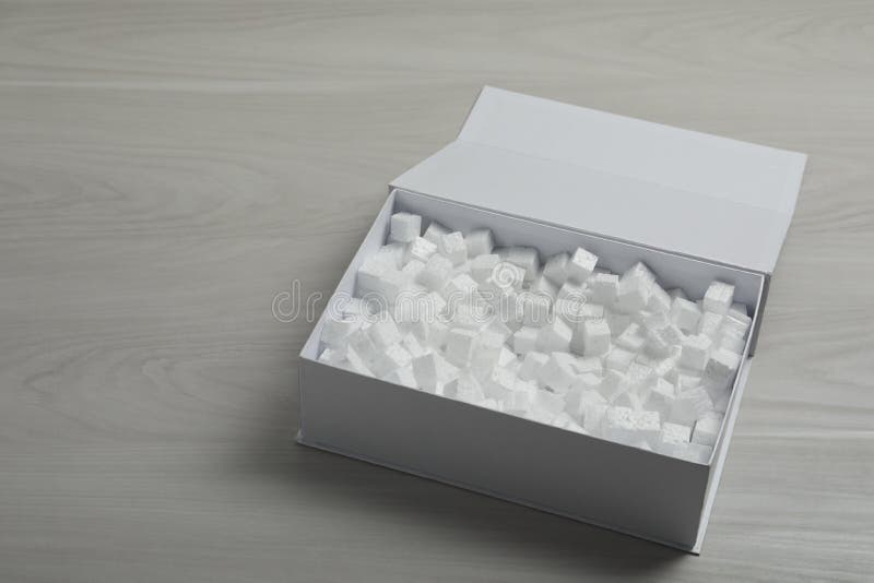 Cardboard Box with Styrofoam Cubes on Wooden Floor. Space for Text ...