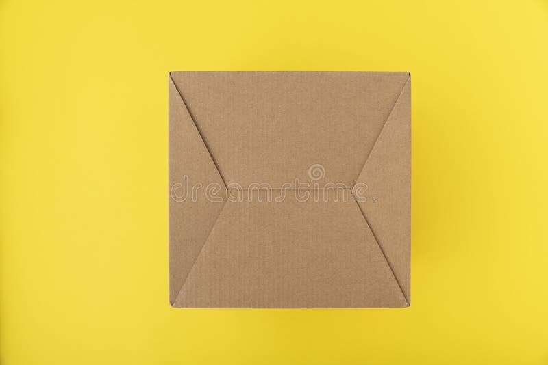 Cardboard Box on Yellow Background. Craft Packaging Stock Photo - Image ...
