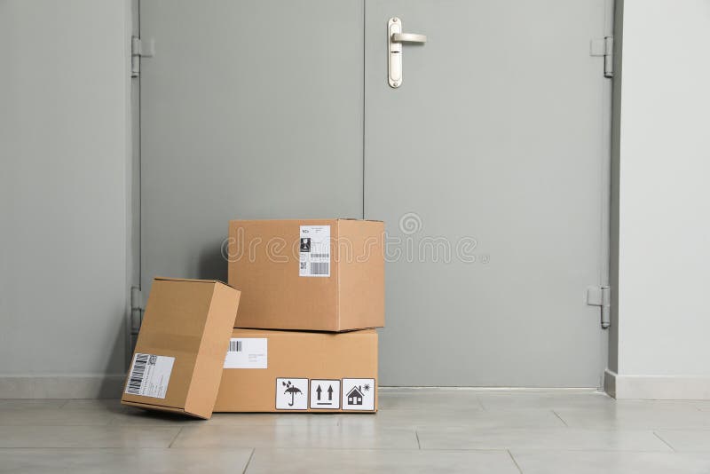 Cardboard Boxes on Floor Near Entrance. Parcel Delivery Service Stock ...