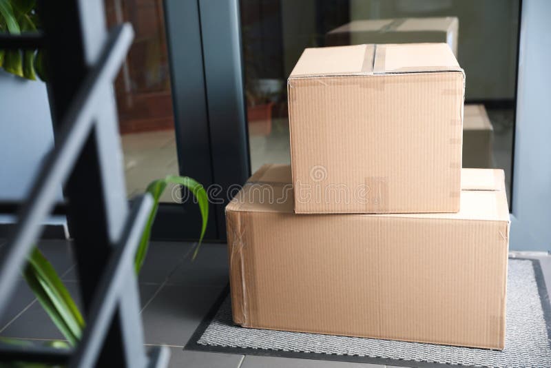 Cardboard Boxes on Rug Near Door. Parcel Delivery Service Stock Image ...