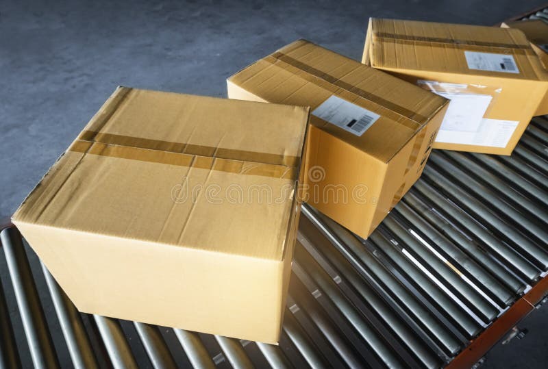 Cardboard Boxes Sorting on Roller Conveyor at the Warehouse. Shipment ...