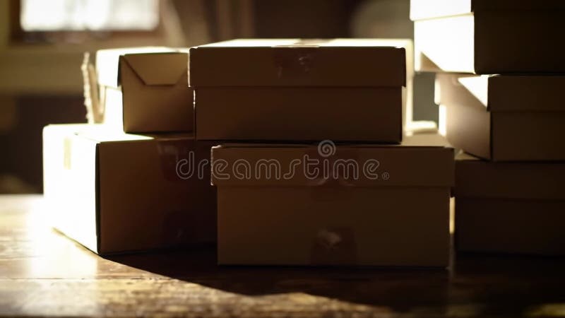 Cardboard Boxes Stacked on Wooden Table in Soft Light Stock Footage - Video of workspace, brown ...