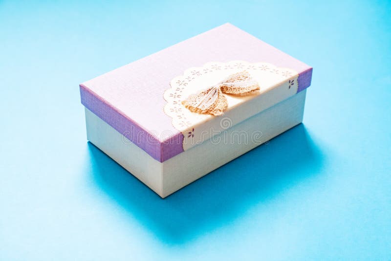 Cardboard Gift Box in Purple Color Scheme with a Bow on a Blue ...