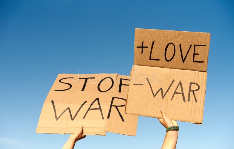 Cardboard Sign Saying More Love, less War, and Stop War Held by Two ... Cardboard Sign Saying More Love, less War, and Stop War Held by Two ...