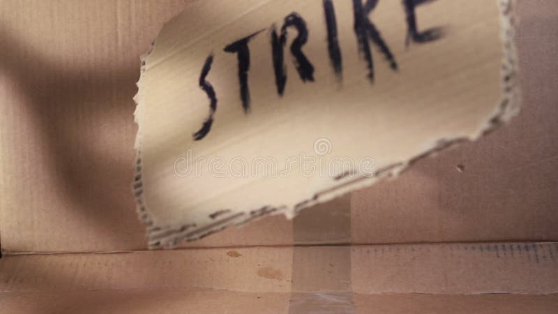 Cardboard with strike word stock footage. Video of conflict - 249786038