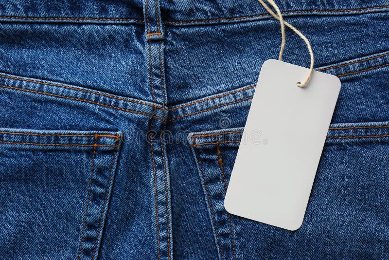 Cardboard Tag with Space for Text on Blue Jeans, Top View Stock Photo ...