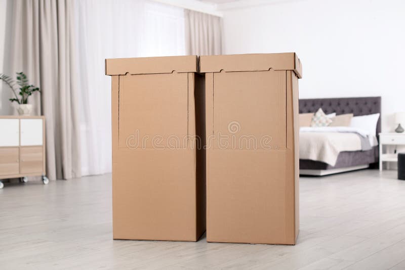Cardboard Wardrobe Boxes with Clothes on Hangers Stock Image - Image of ...