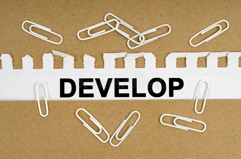 On Cardboard, White Paper Clips and a Sheet from a Notebook with the ...