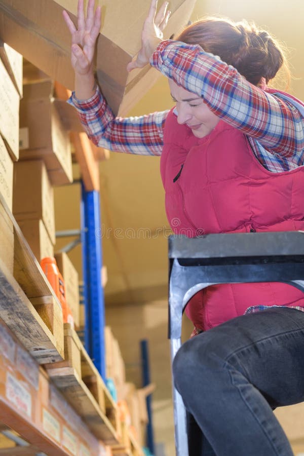 Cardbox Falling Over Female Worker in Warehouse Stock Image - Image of ...