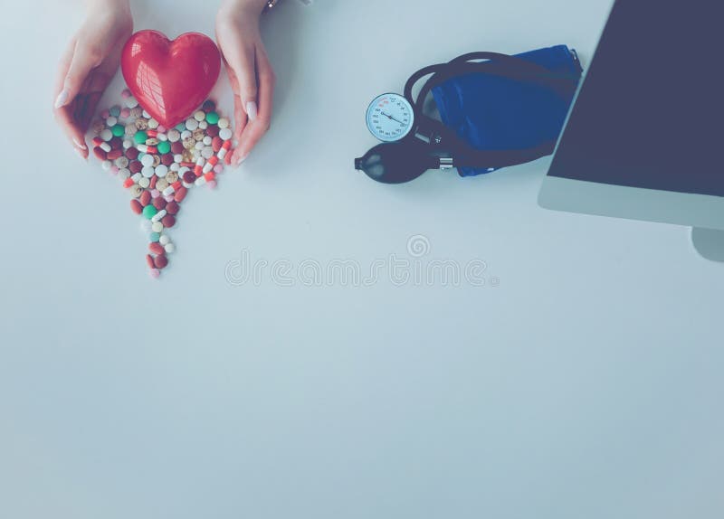 Cardiologist with Red Heart and Stethoscope at Table Stock Photo ...